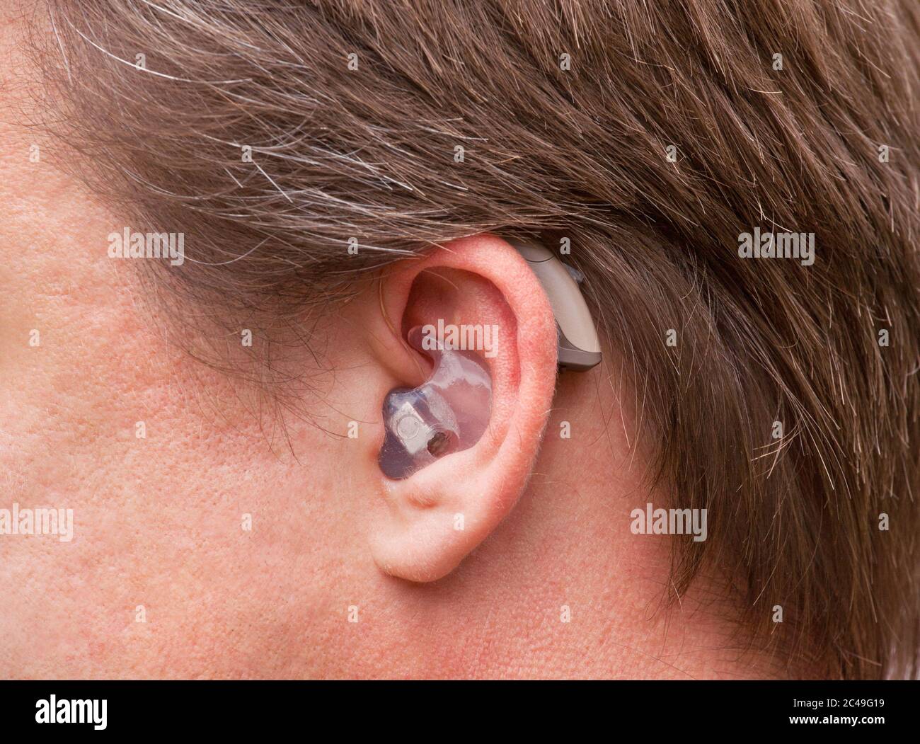 Behind the ear hearing aid hi-res stock photography and images - Alamy