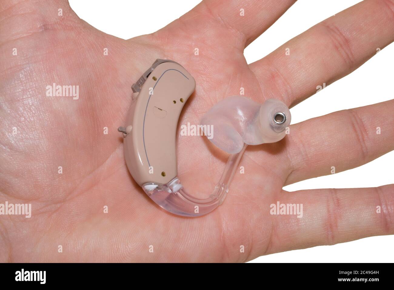 A palm holds a digital hearing aid with earmould and tubing Stock Photo ...