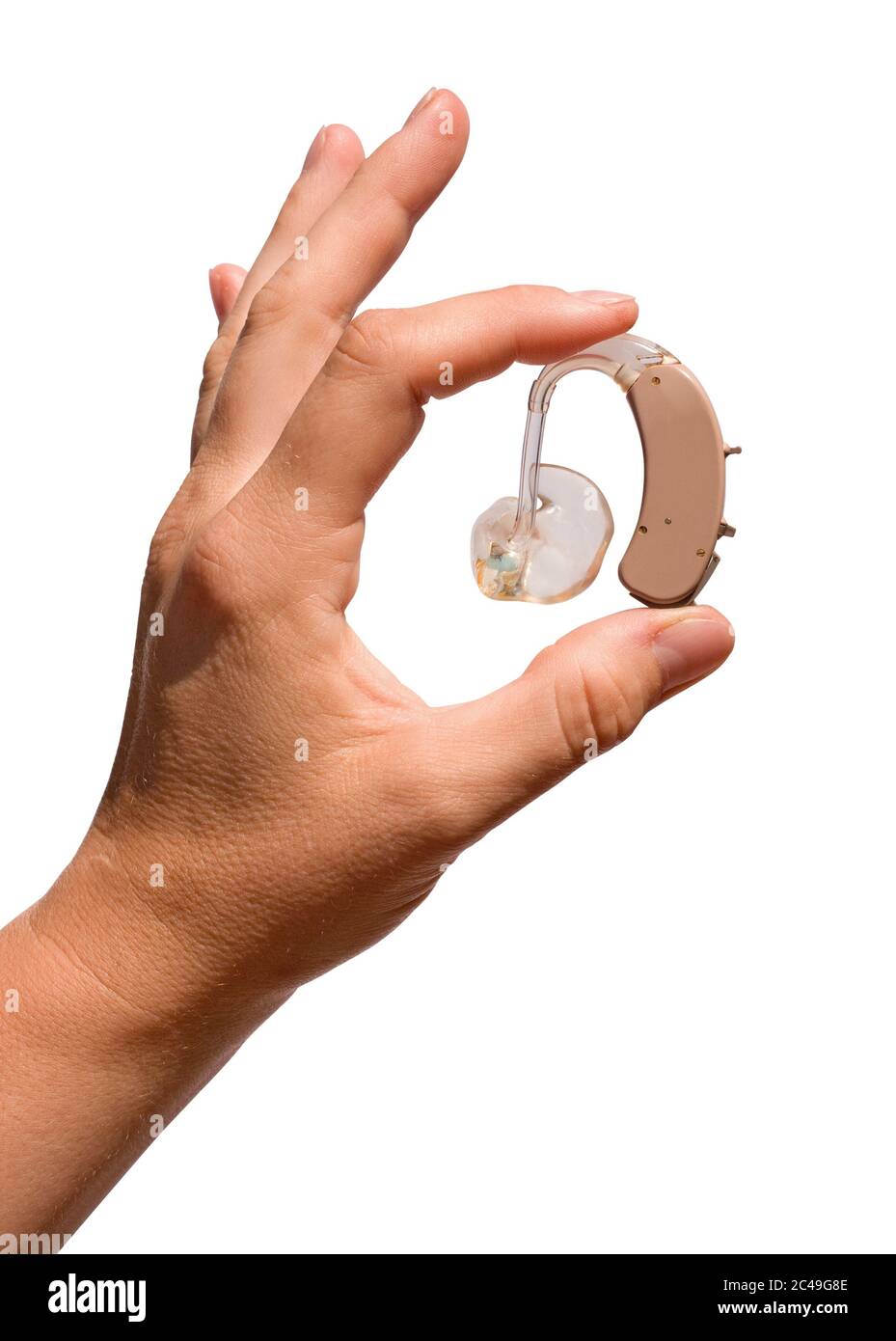 A woman's hand holding a digital hearing aid with ear mould and tubing ...