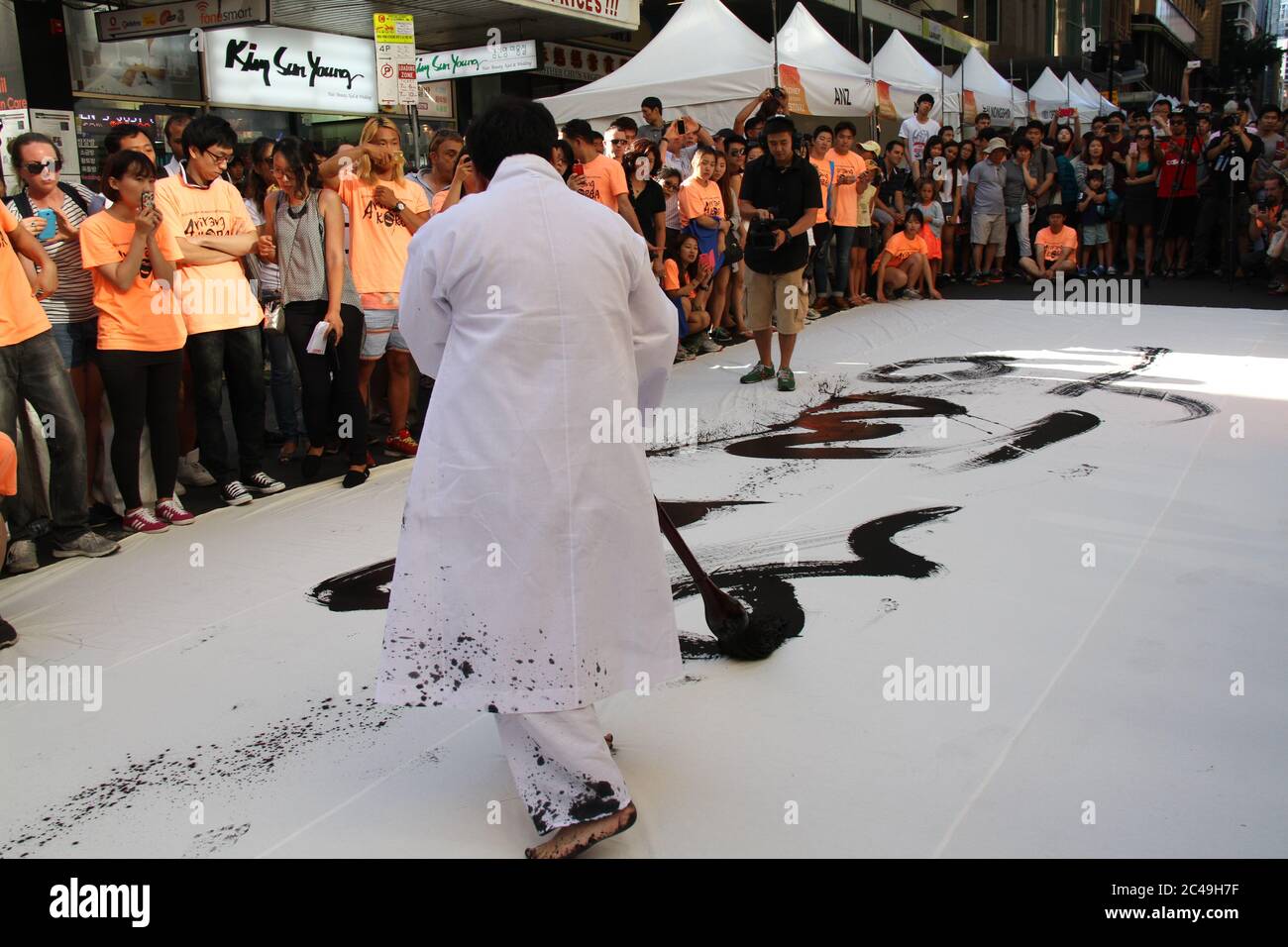 People watch a giant calligraphy performance at the Sydney Koreatown ...