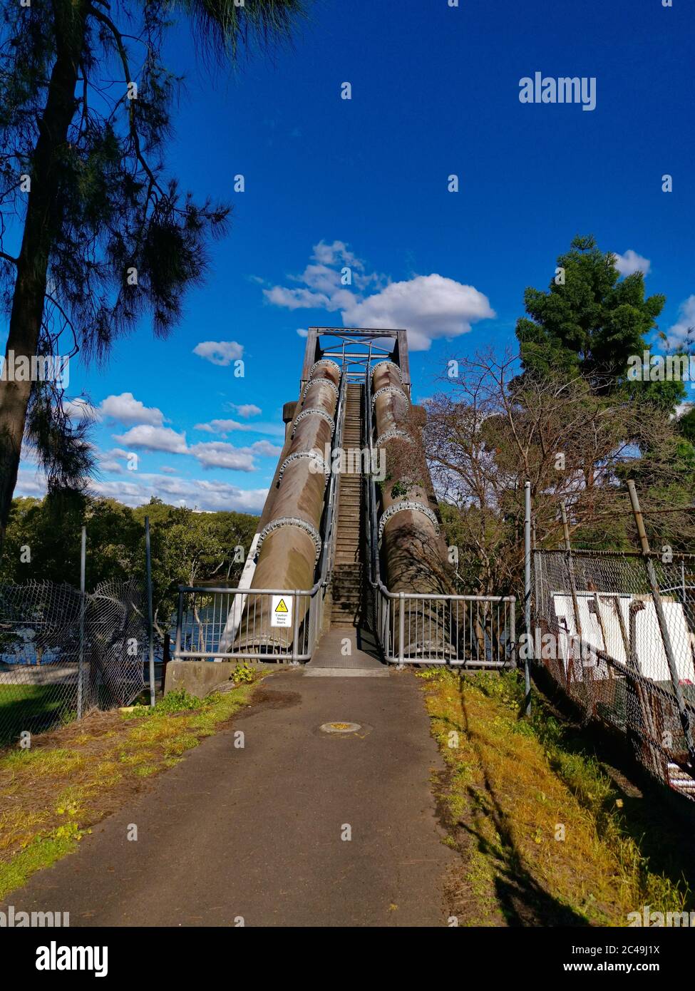 Tall pedestrian and water pipe bridge across the Parramatta river ...
