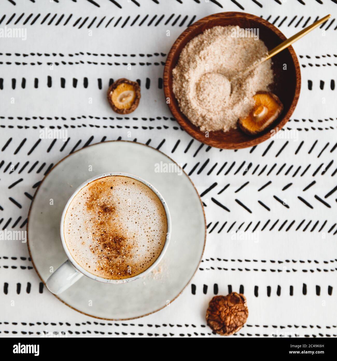 Top view of cappuccino coffee with shiitake mushroom powder. Immune and ...
