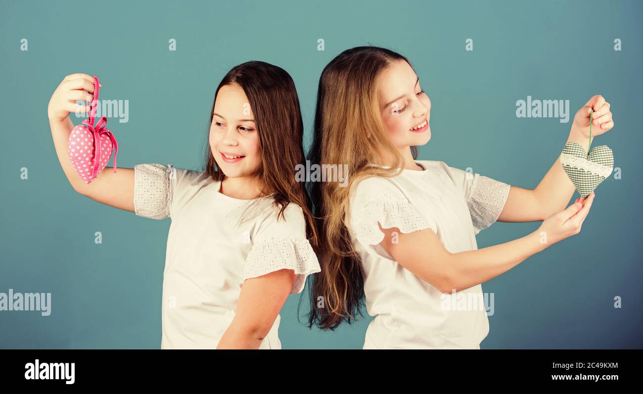 Love concept. Girls cute kids hold heart shaped toys. Symbol of love ...