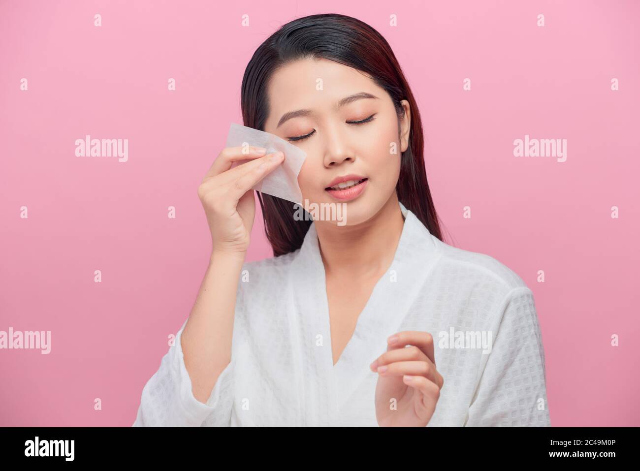 Beautiful attractive asian woman using facial oil clean film to removal ...