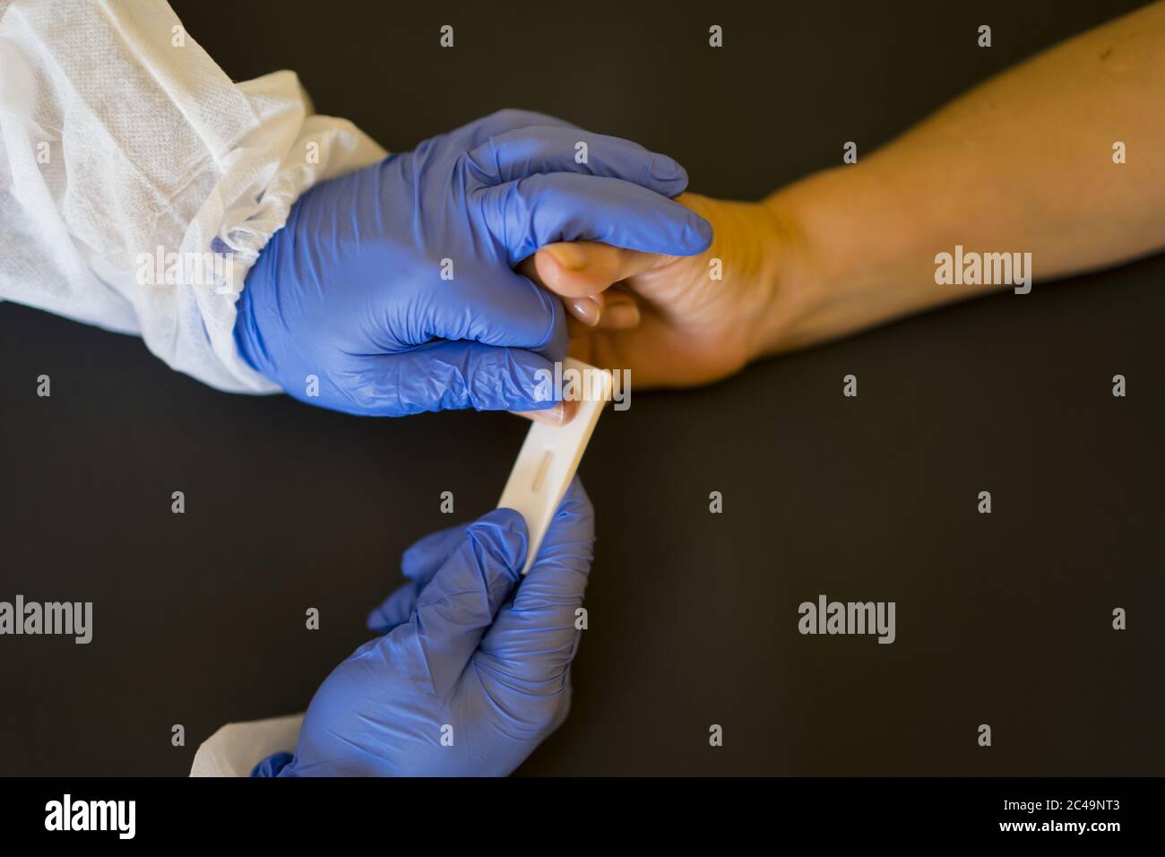 Doctor taking a blood sample from the patient's finger Stock Photo - Alamy