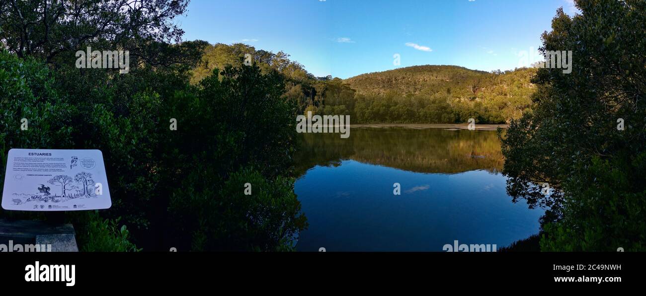 Beautiful panoramicview of a creek with reflection of blue sky ...