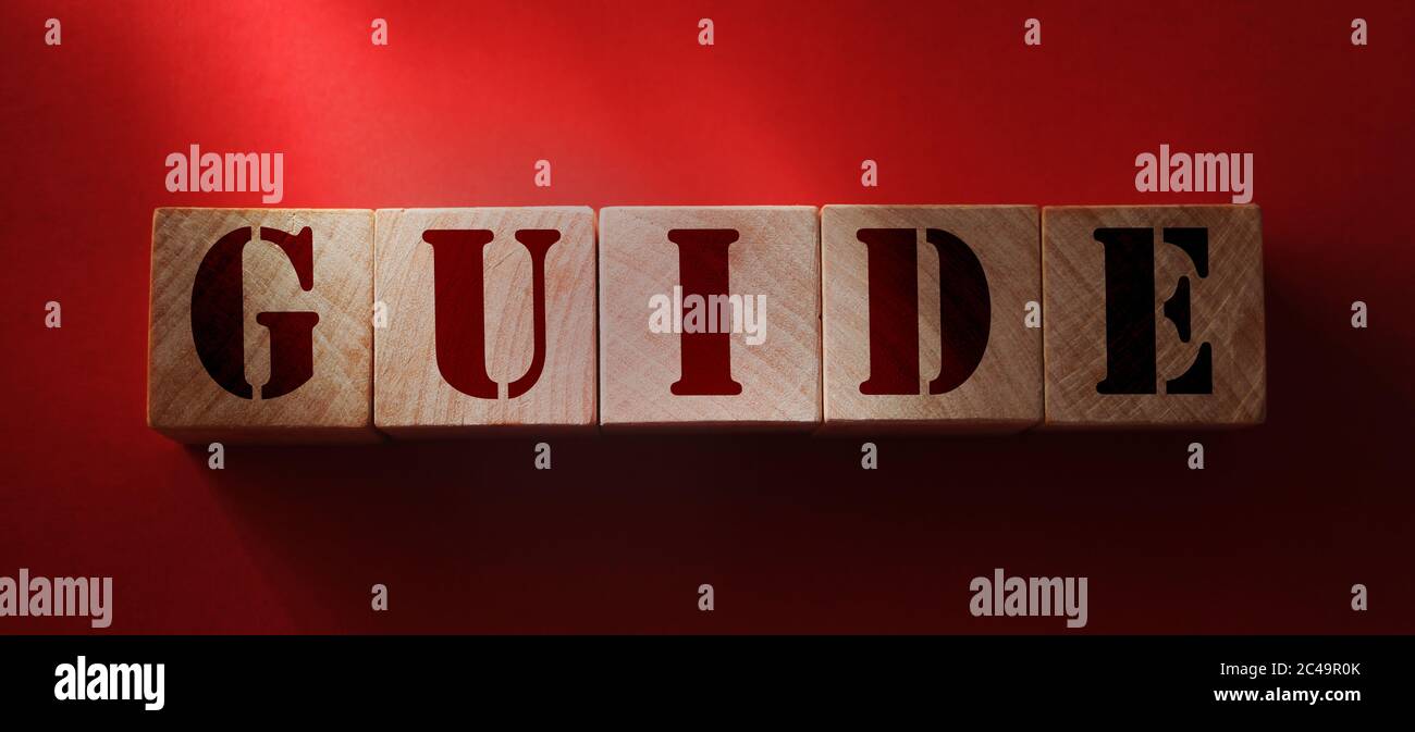 Guide Word Written on Wooden Cubes on red background Stock Photo - Alamy