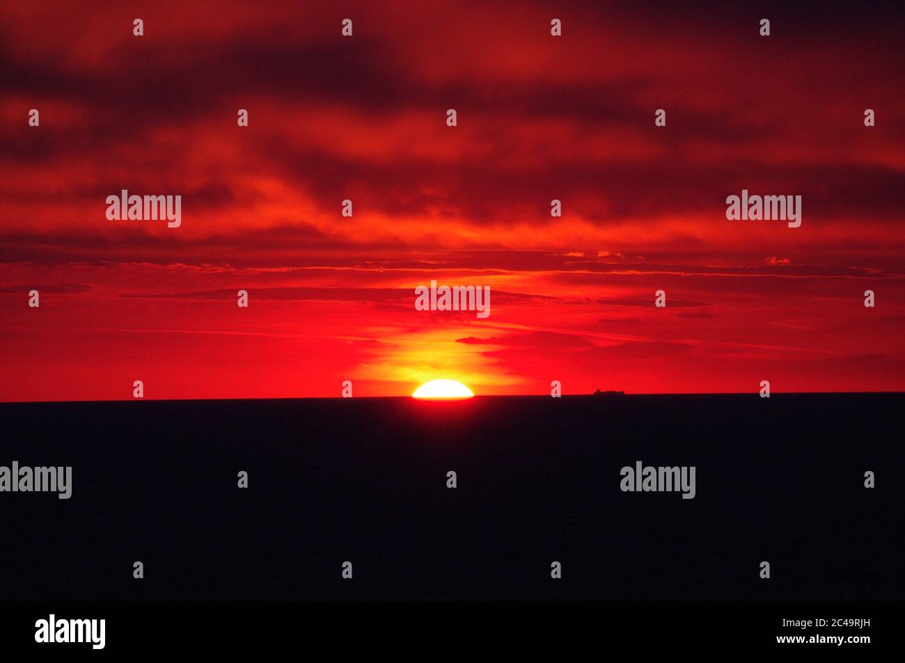 Sequence of Images of a Sunset, Fiery Red sunset over dark sea with ...