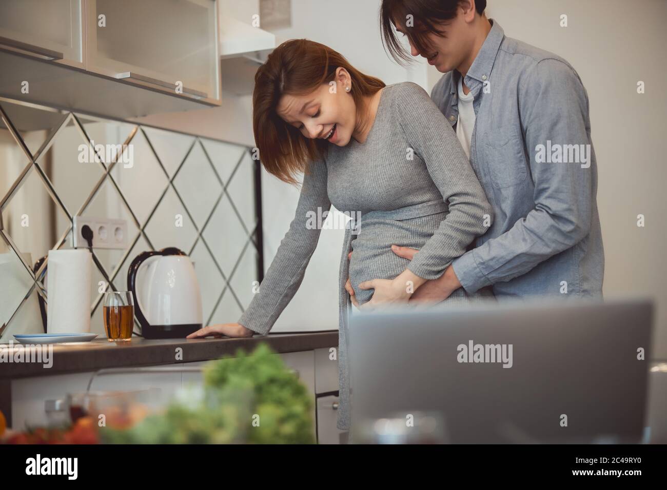 Excited young couple feeling the baby pushing inside the belly Stock ...