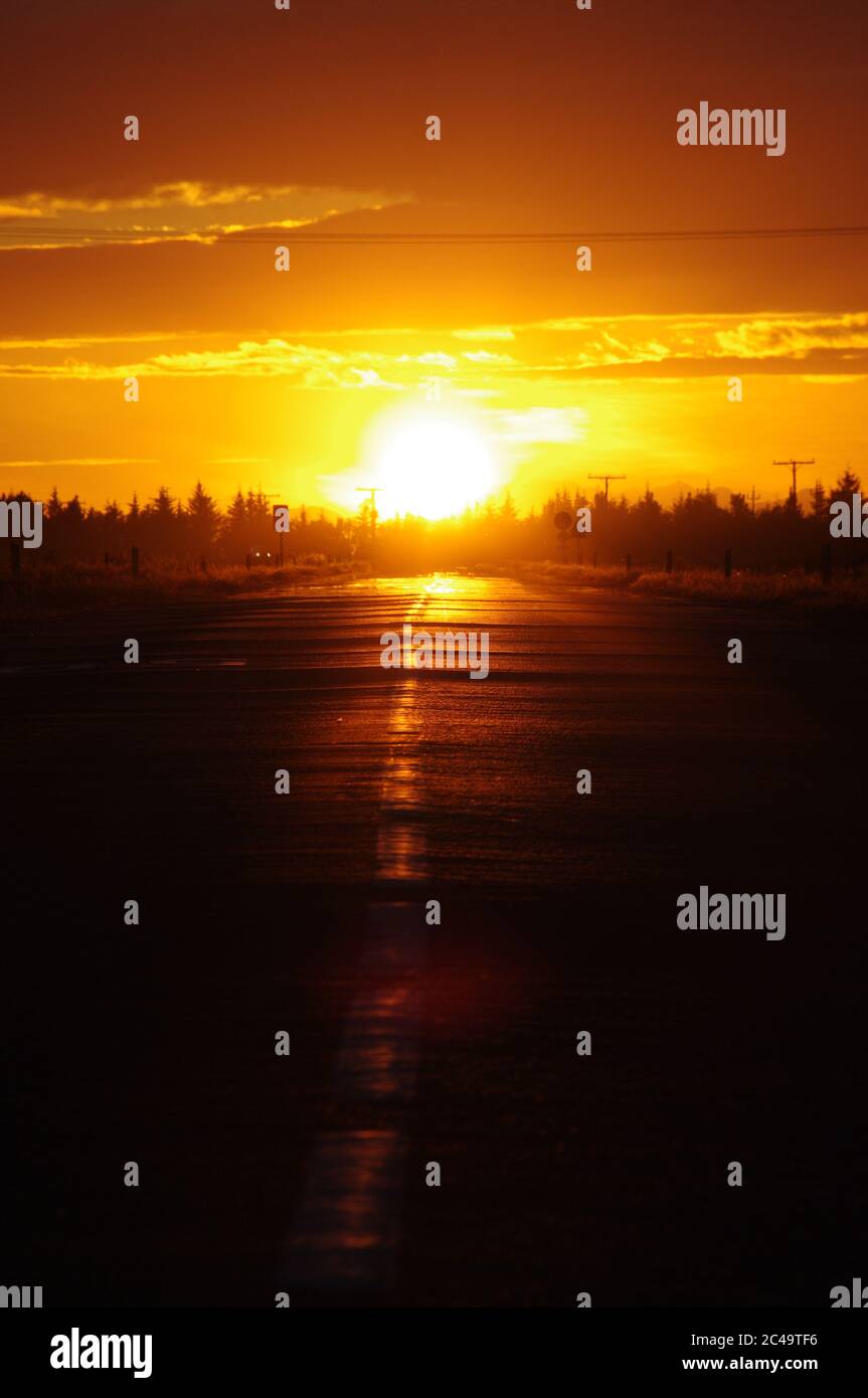Sequence of images of a sunset, Setting sun at end of road, yellow ...