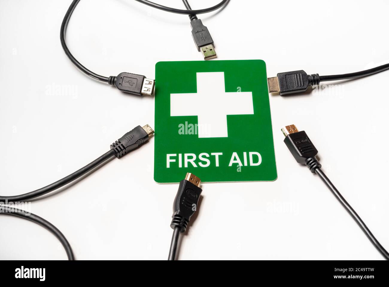 Green sign [ FIRST AID] written on it with various black wires isolated ...