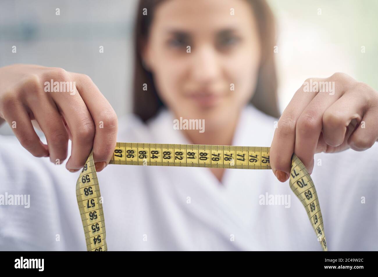 Woman holding up ruler hi-res stock photography and images - Alamy