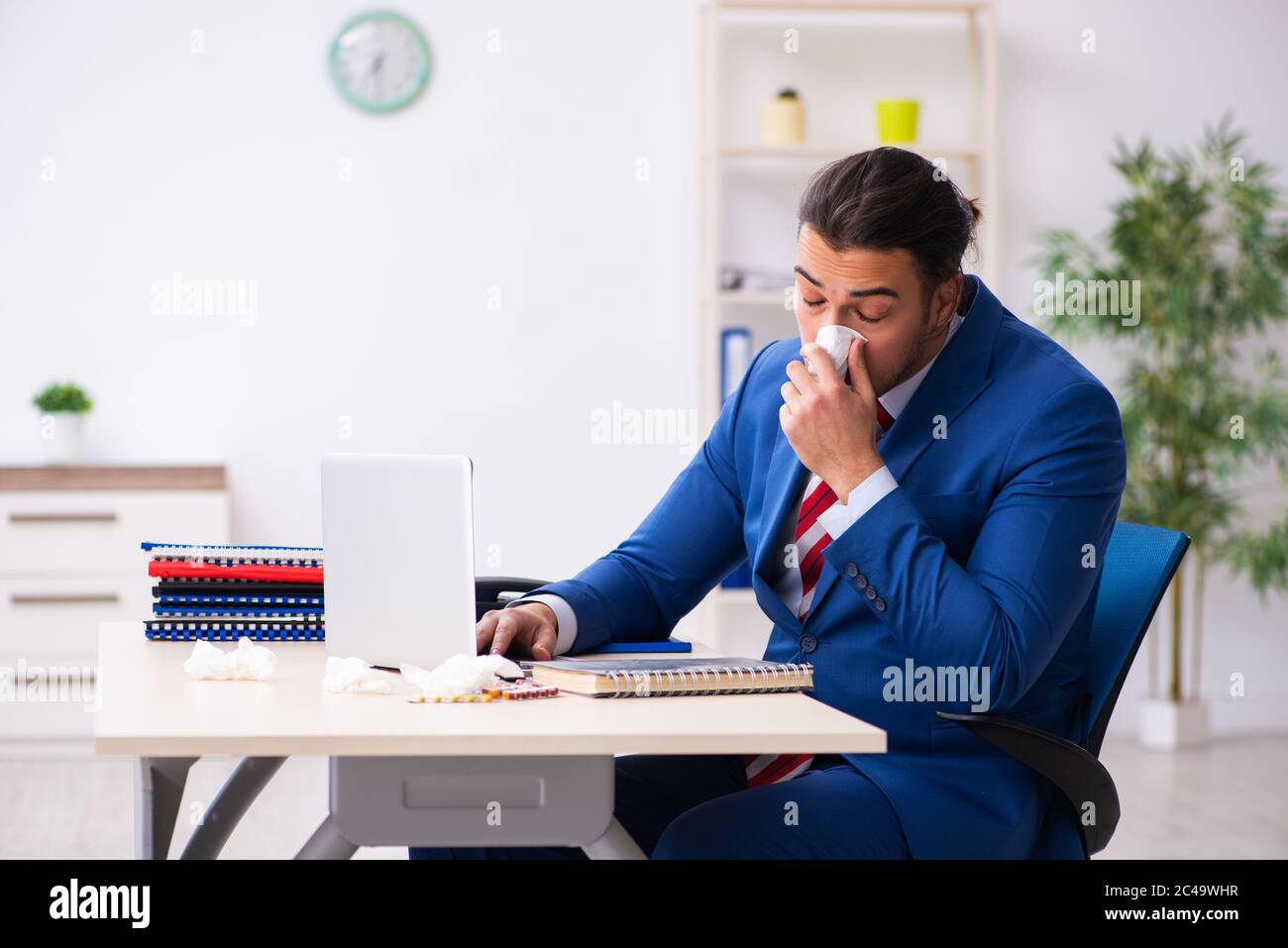 Sick employee suffering at workplace from covid-19 Stock Photo - Alamy