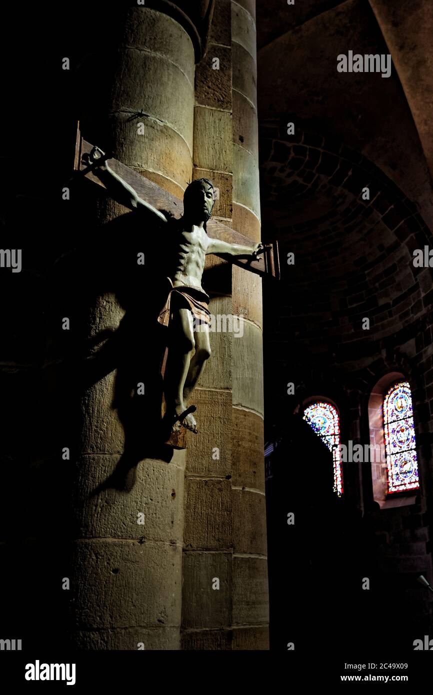 Statue of Jesus Christ crucifixion on a brick wall background in a dark ...