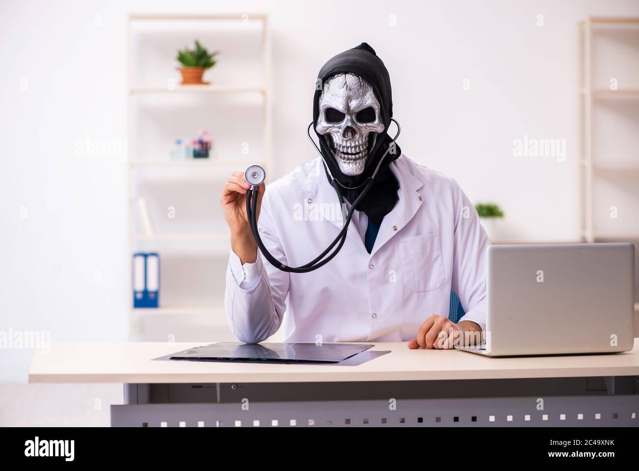 Male devil doctor working in clinic Stock Photo - Alamy