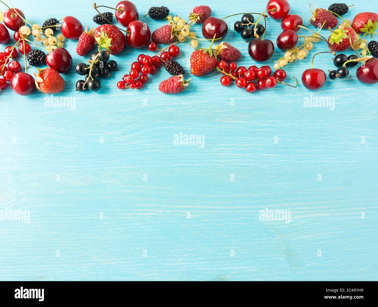 Black and red fruits. Ripe red currants, strawberries, raspberries ...