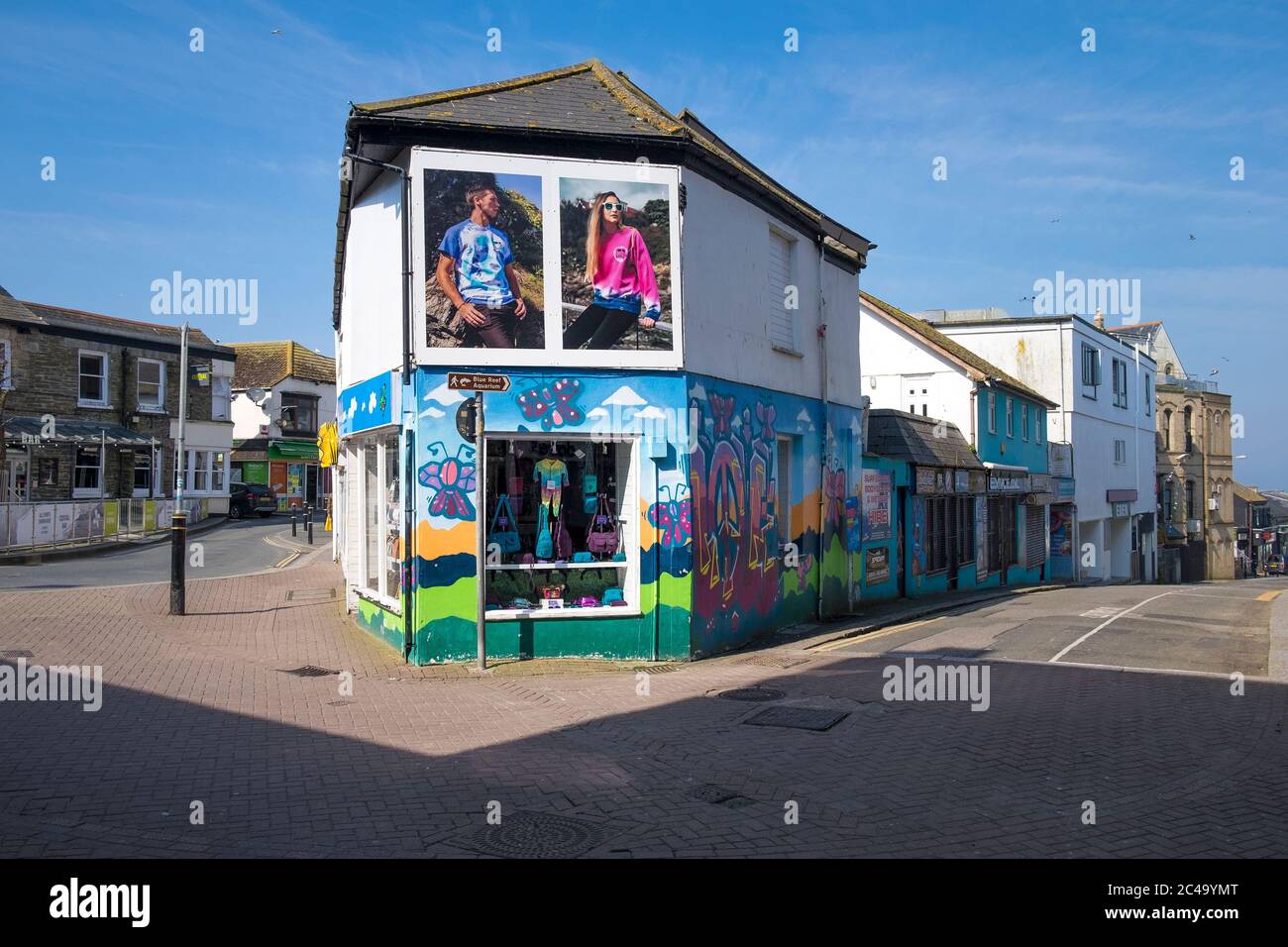 A corner clothing shop store with colourful walls in Newquay Town ...