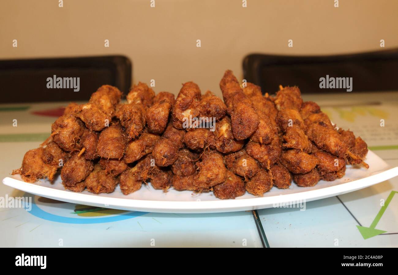 Pile of spicy chicken sticks on a platter Stock Photo - Alamy