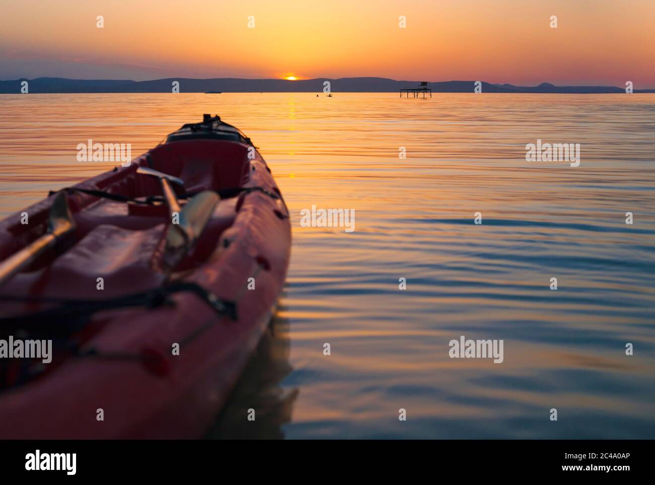 Lake Balaton sunset with a kayak in the front Stock Photo - Alamy