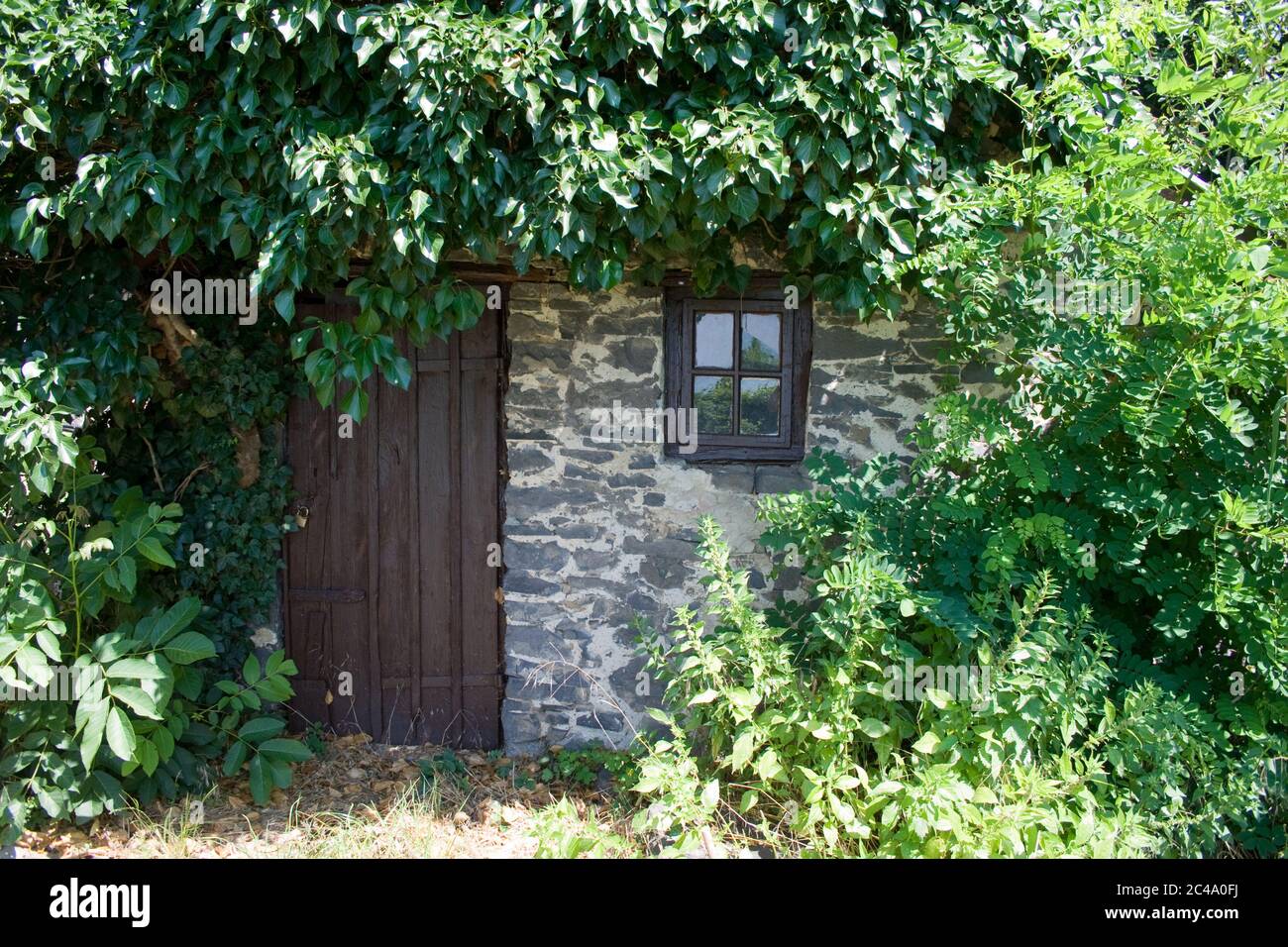 Romantic basalt stone house detail with window and door surrounded by ...