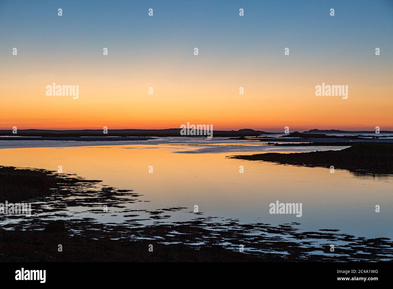 A dramatic sunset over the water, viewed from near the causeway between ...