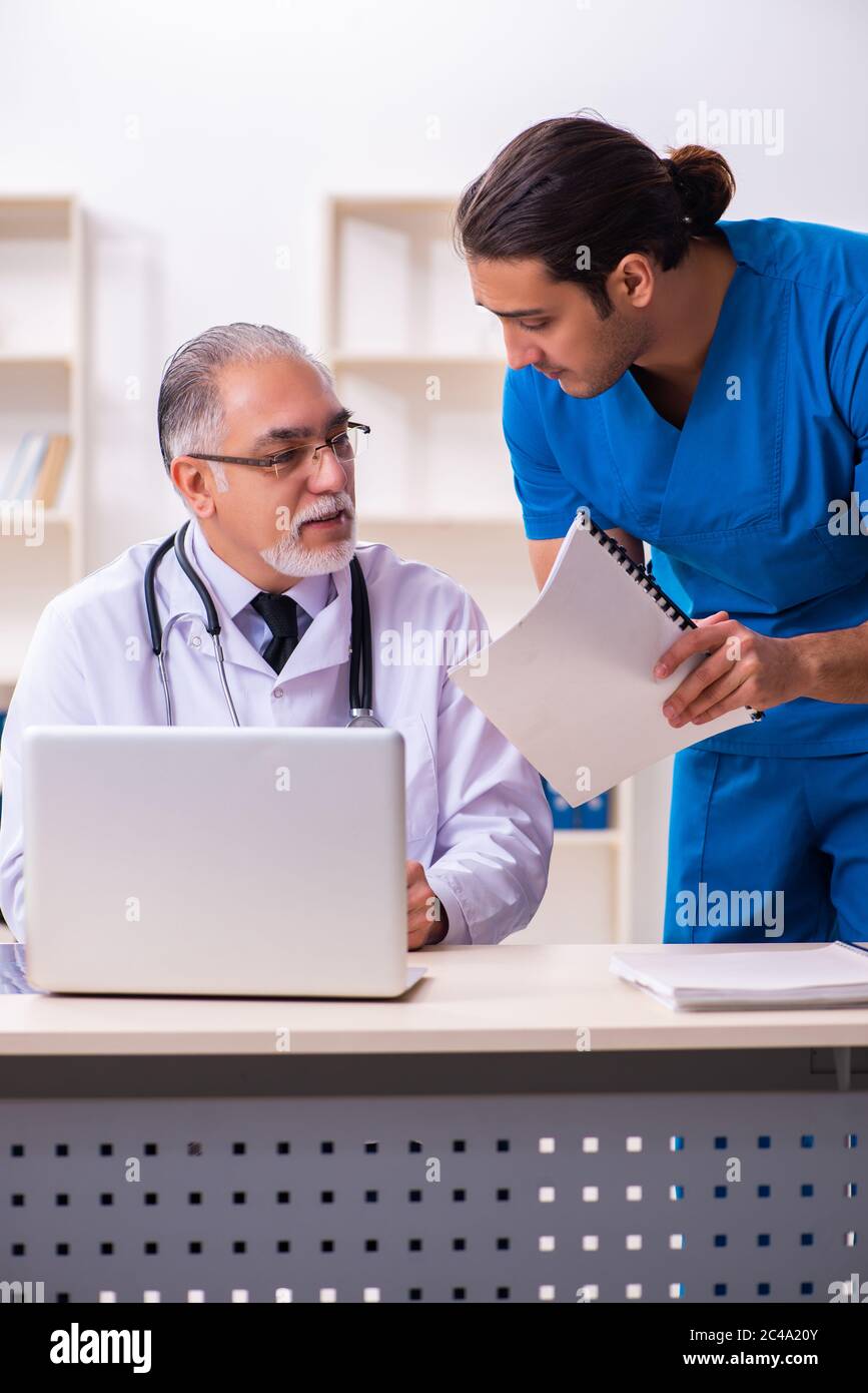 Two male doctors examining laptop hi-res stock photography and images ...