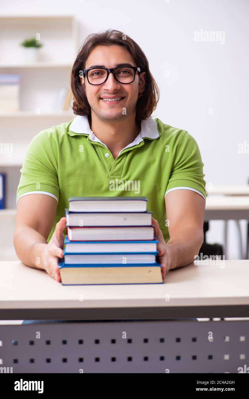 Young male student in the classroom studying Stock Photo - Alamy