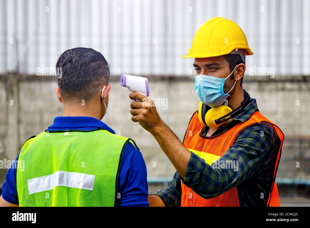 Worker check body temperature Before working in the warehouse To ...