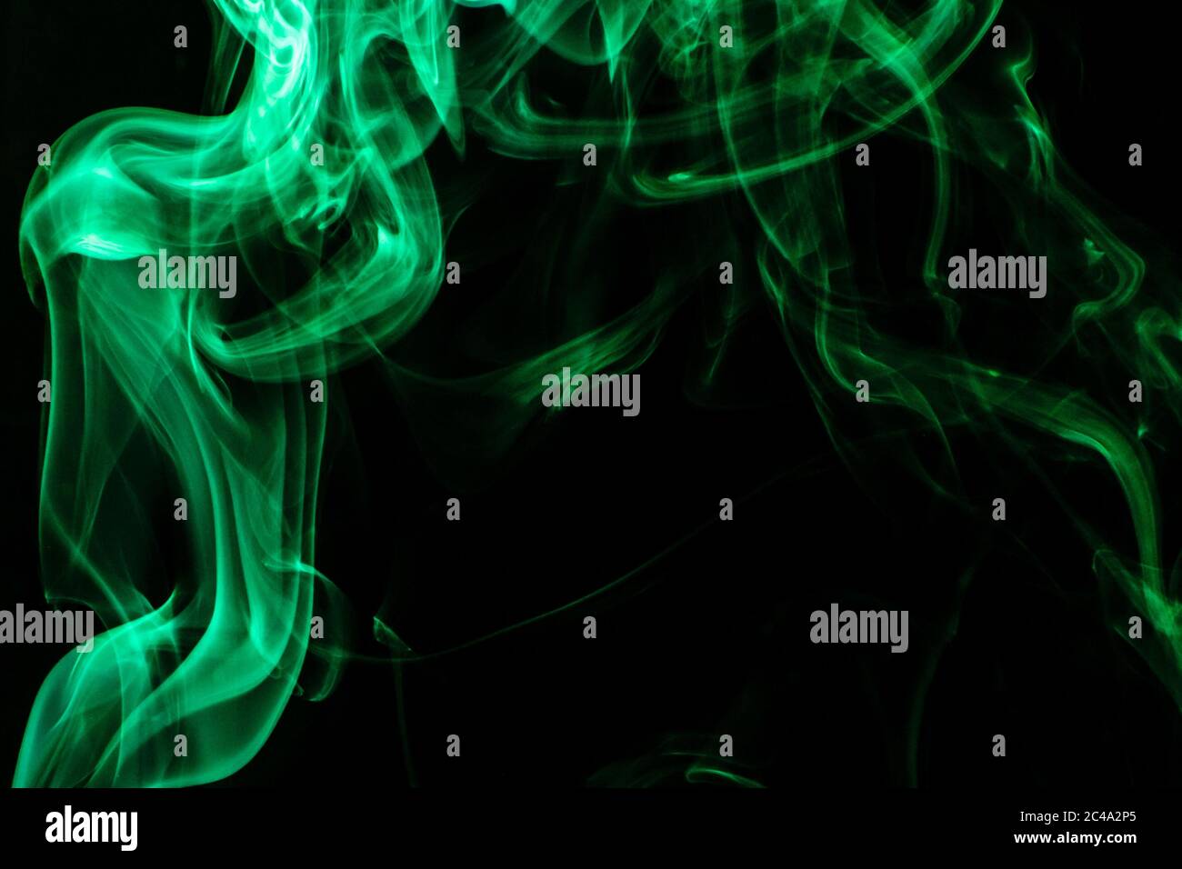 Green colored puffed smoke in a dark background Stock Photo - Alamy
