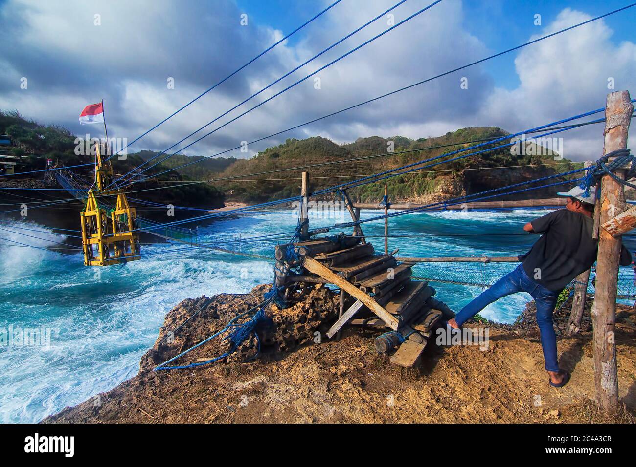 Timang Beach, Yogyakarta - August 19th, 2017: Action from a man pulling ...