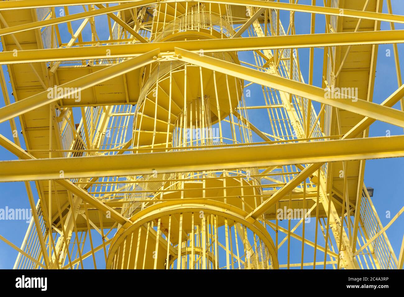 Industrial construction - Yellow metal structure with vivid blue sky ...