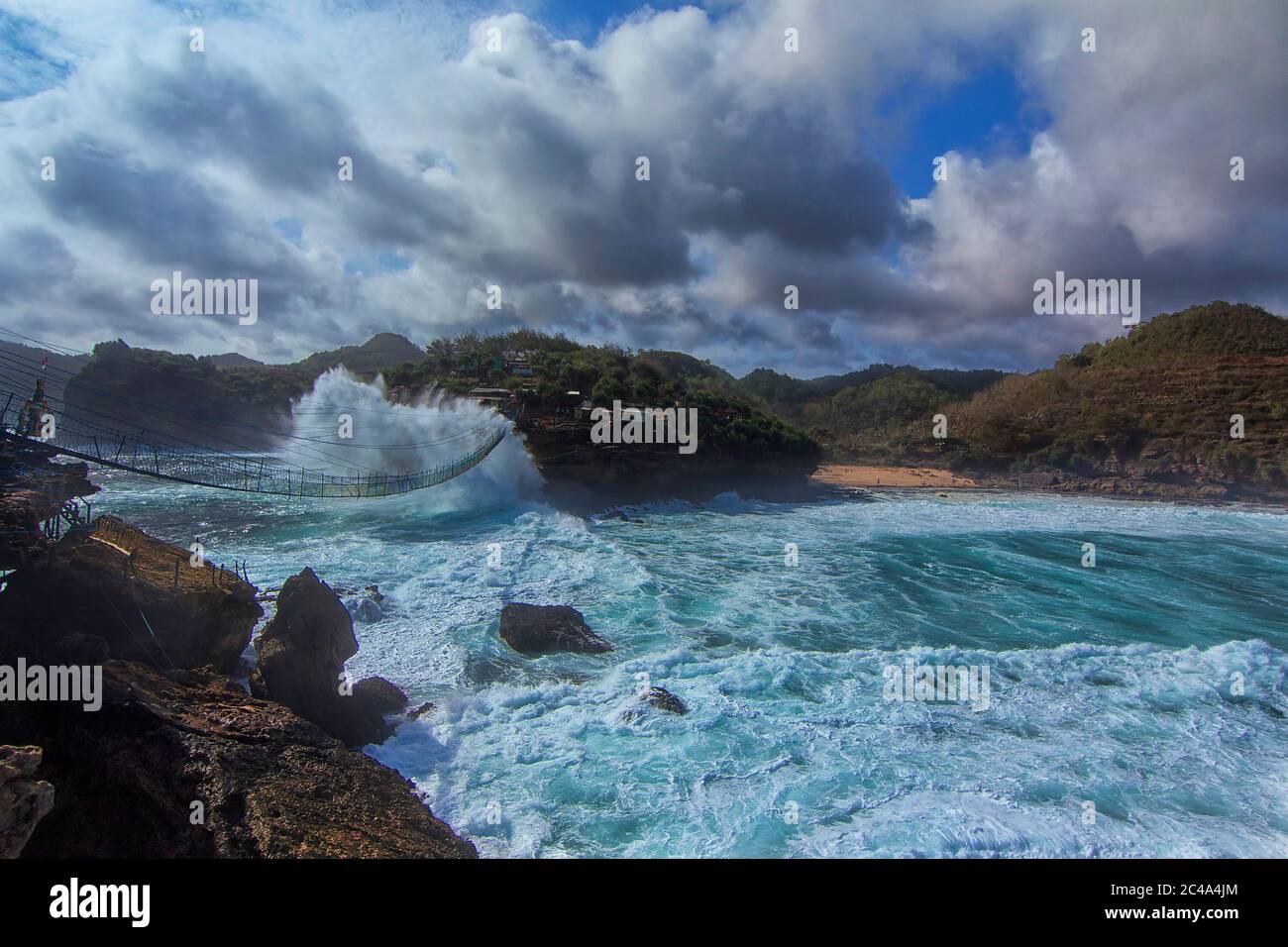 Landscape view of Timang Beach hit by a big wave and in frame is its ...