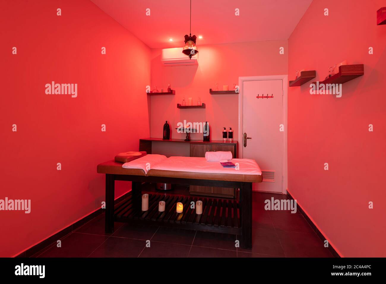 Massage table with candle room interior Stock Photo - Alamy