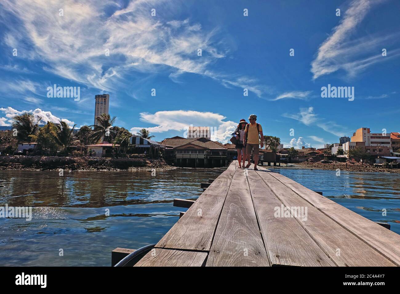 Penang, Malaysia - July 17th, 2016: A couple walking down old jetty in ...