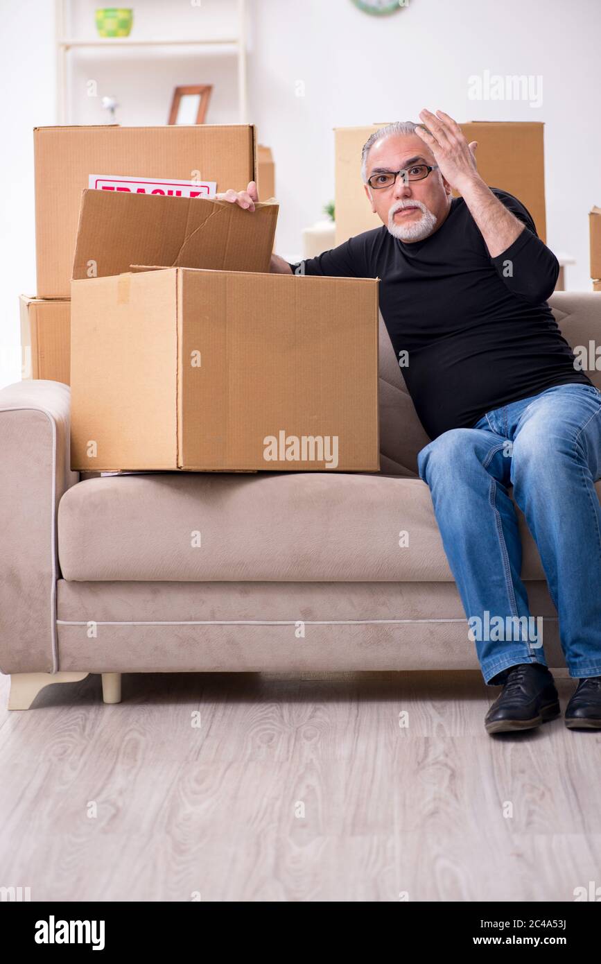 Old man opening cardboard box hi-res stock photography and images - Alamy