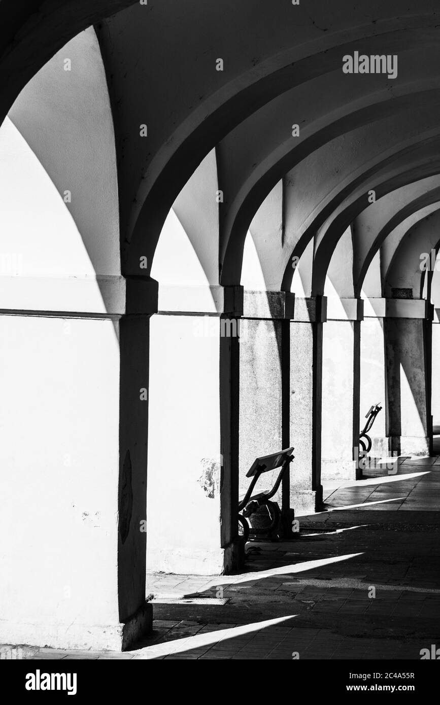 Old historical arcade with benches in old town. Black and white image ...