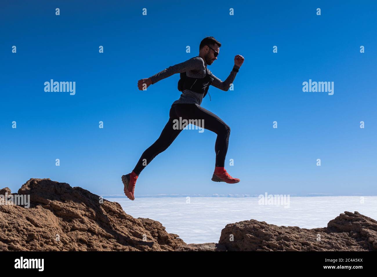 Silhouette man jumping over cliff hi-res stock photography and images ...