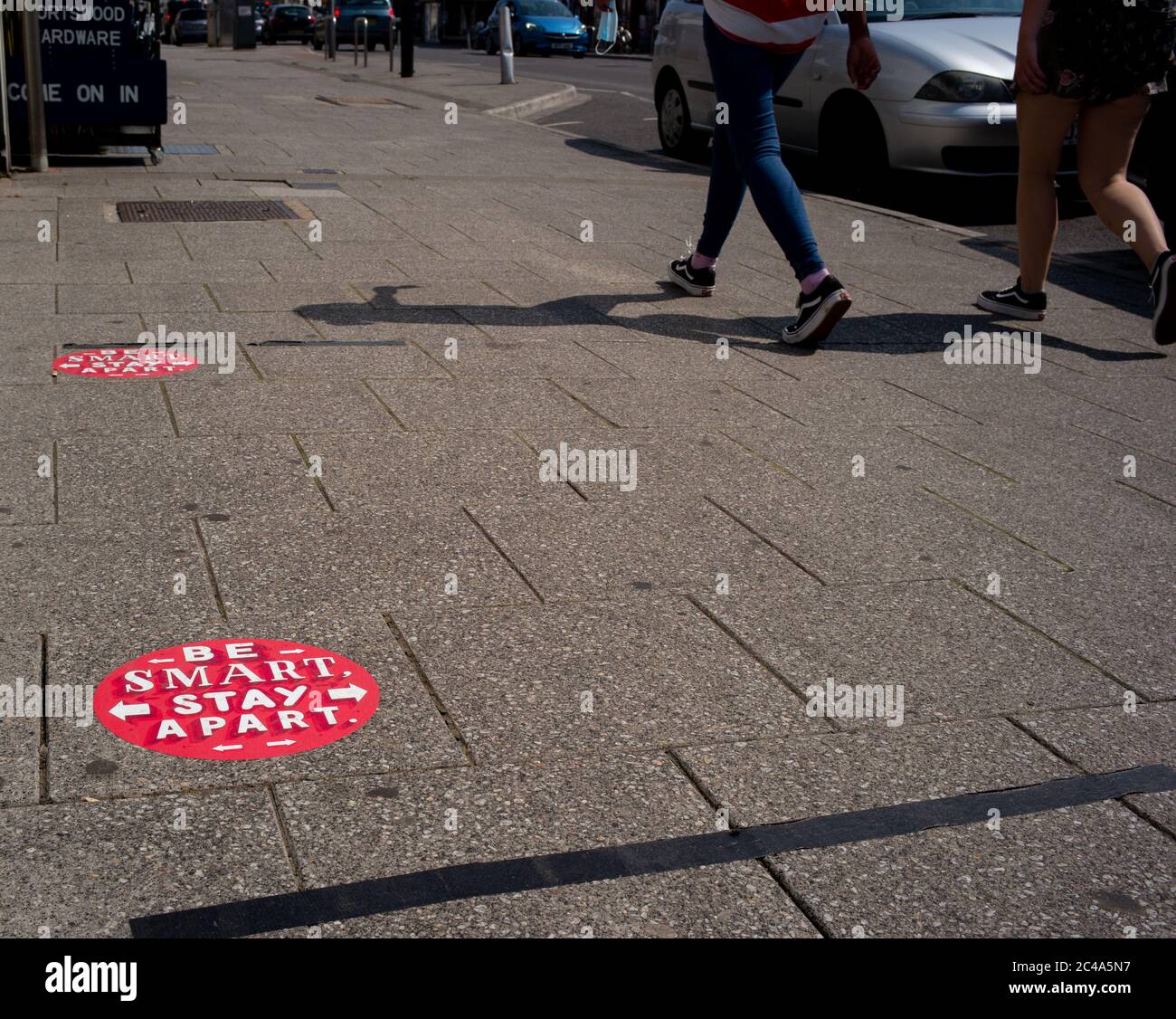 Social distancing signs on the pavement during the coronavirus pandemic ...