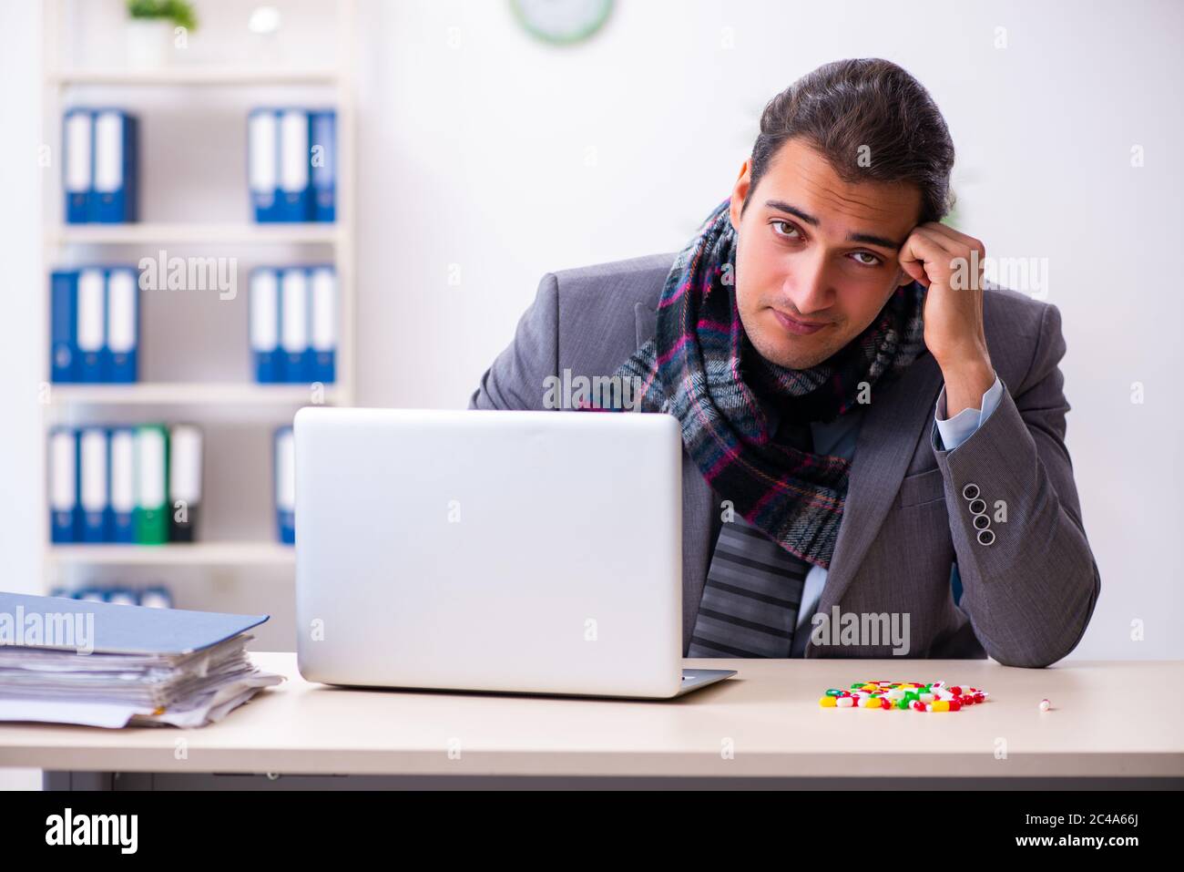 Young employee suffering at workplace Stock Photo - Alamy