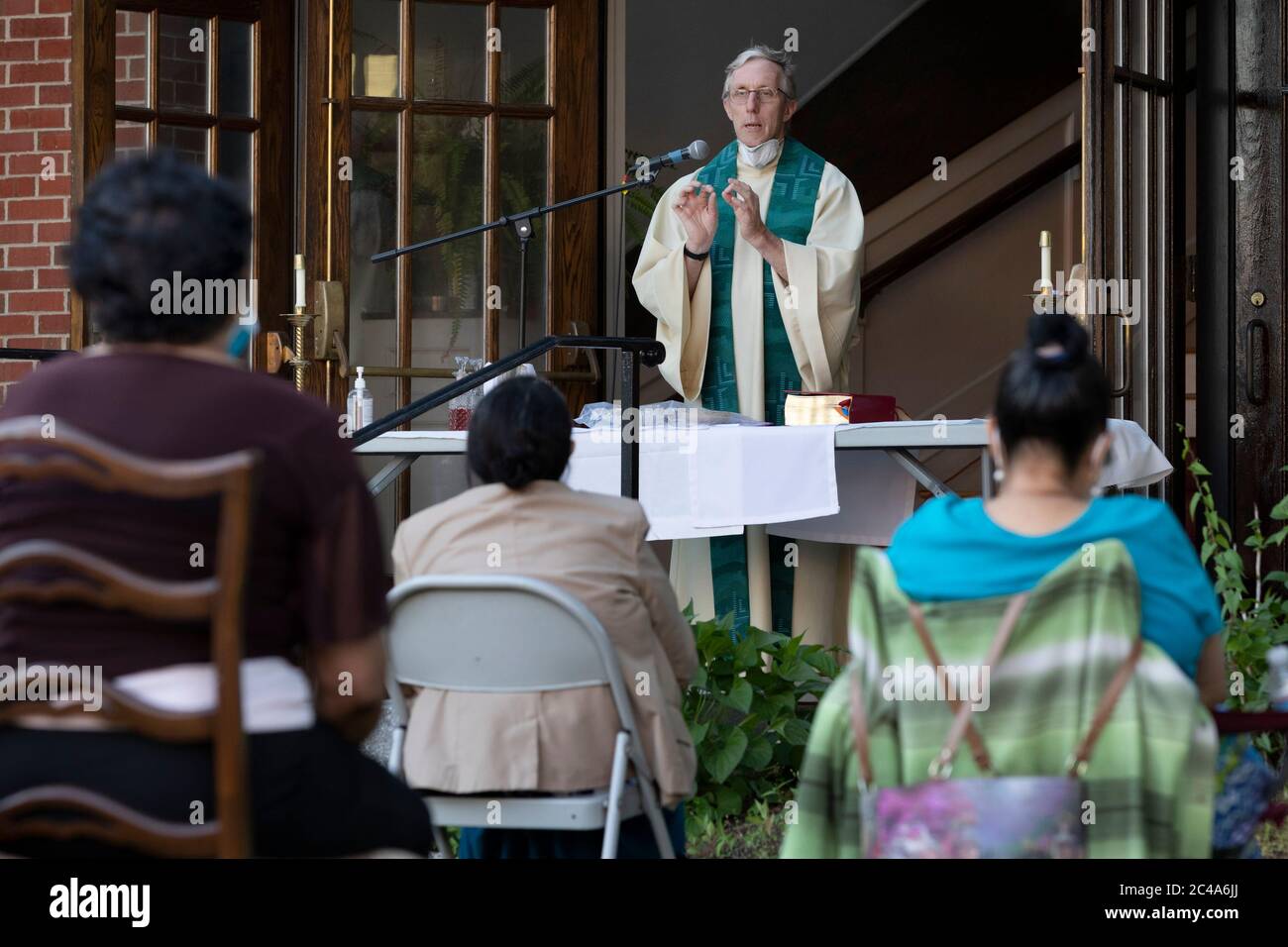 A Catholic priest says Mass in Spanish at an outdoor service Stock ...