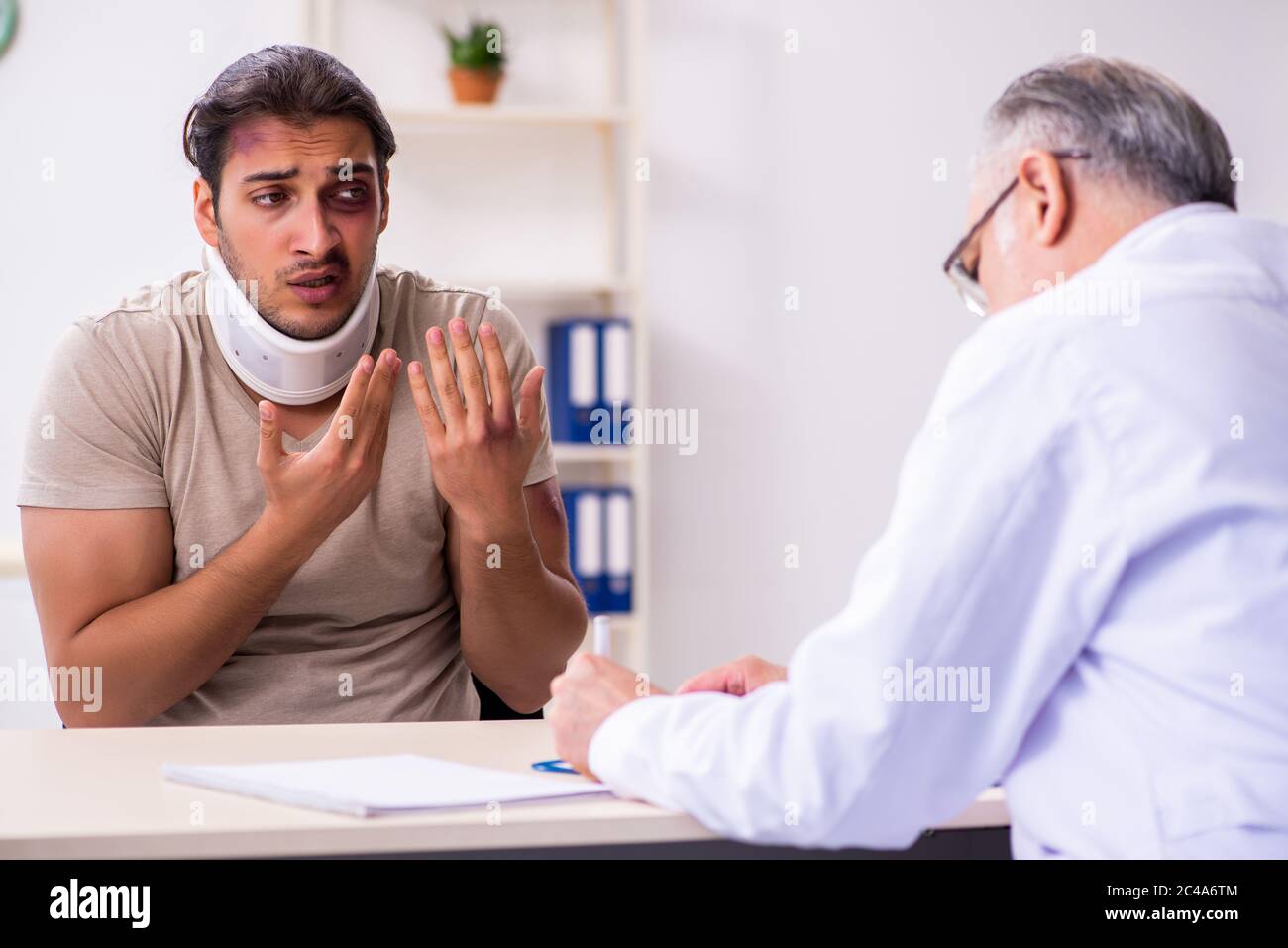 Young face injured man visiting experienced male doctor traumatologist ...
