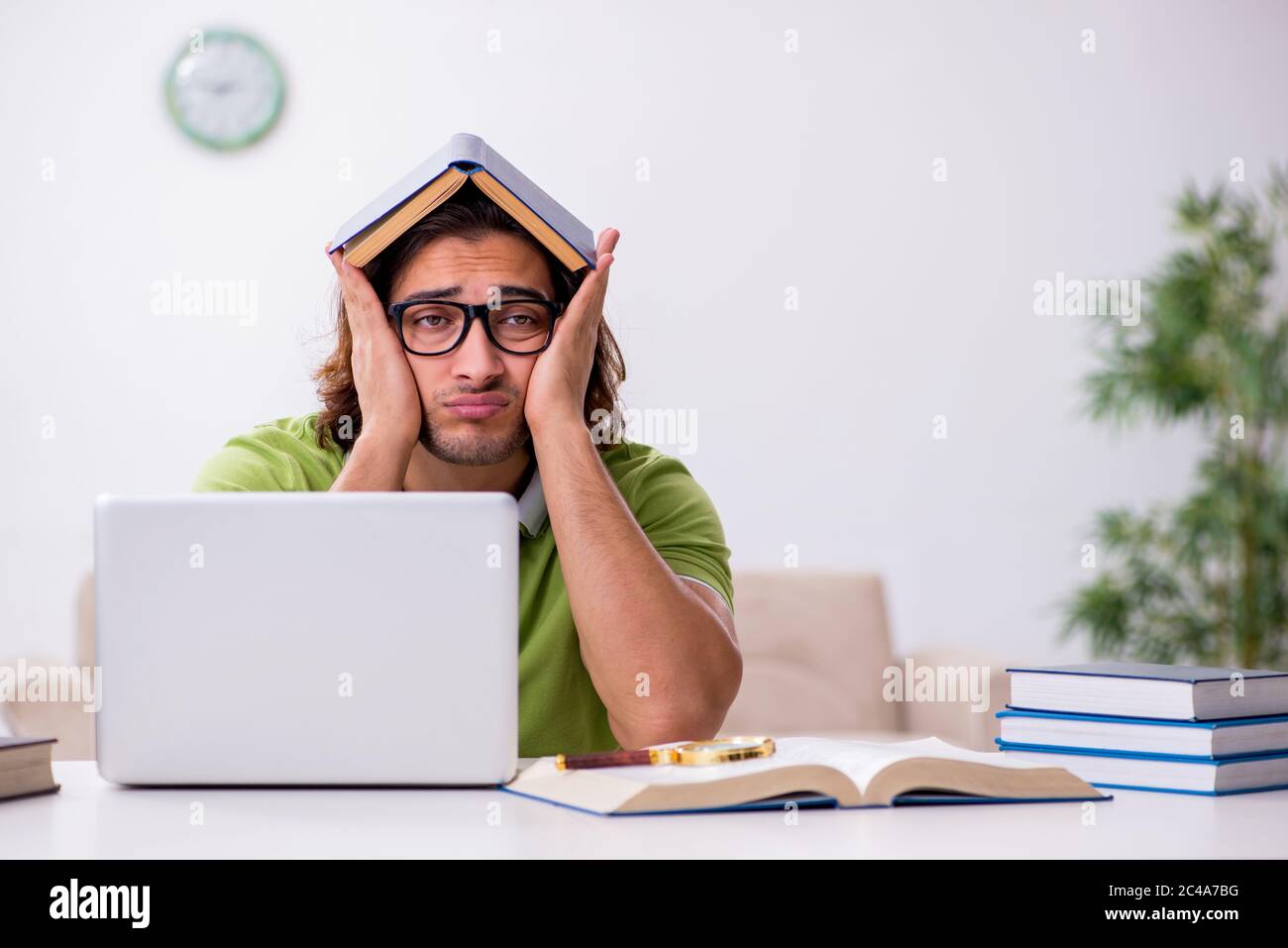 Young student preparing for exams at home Stock Photo - Alamy