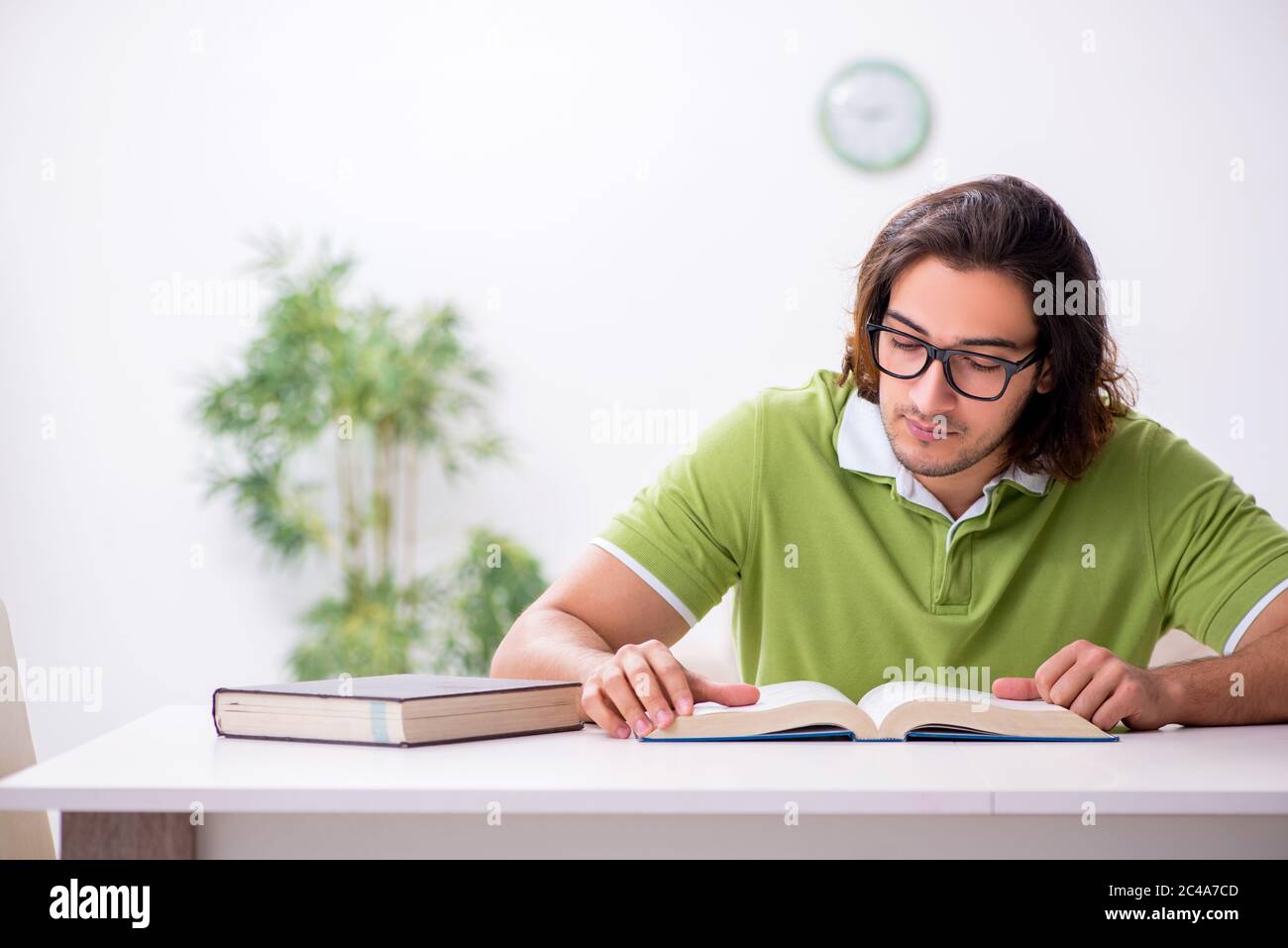 Young student preparing for exams at home Stock Photo - Alamy