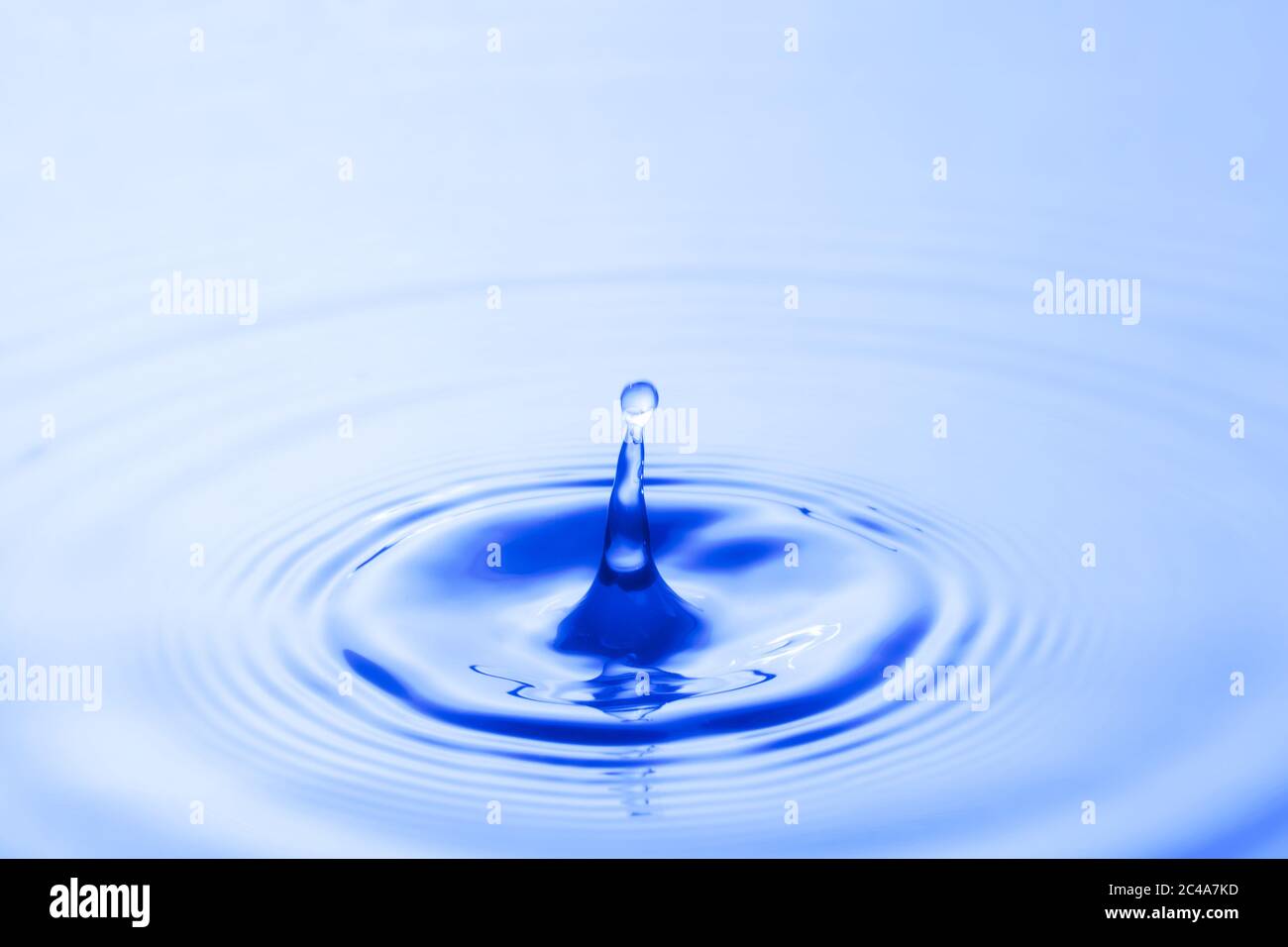 Water droplet falling impact with water surface. causing rings on water ...