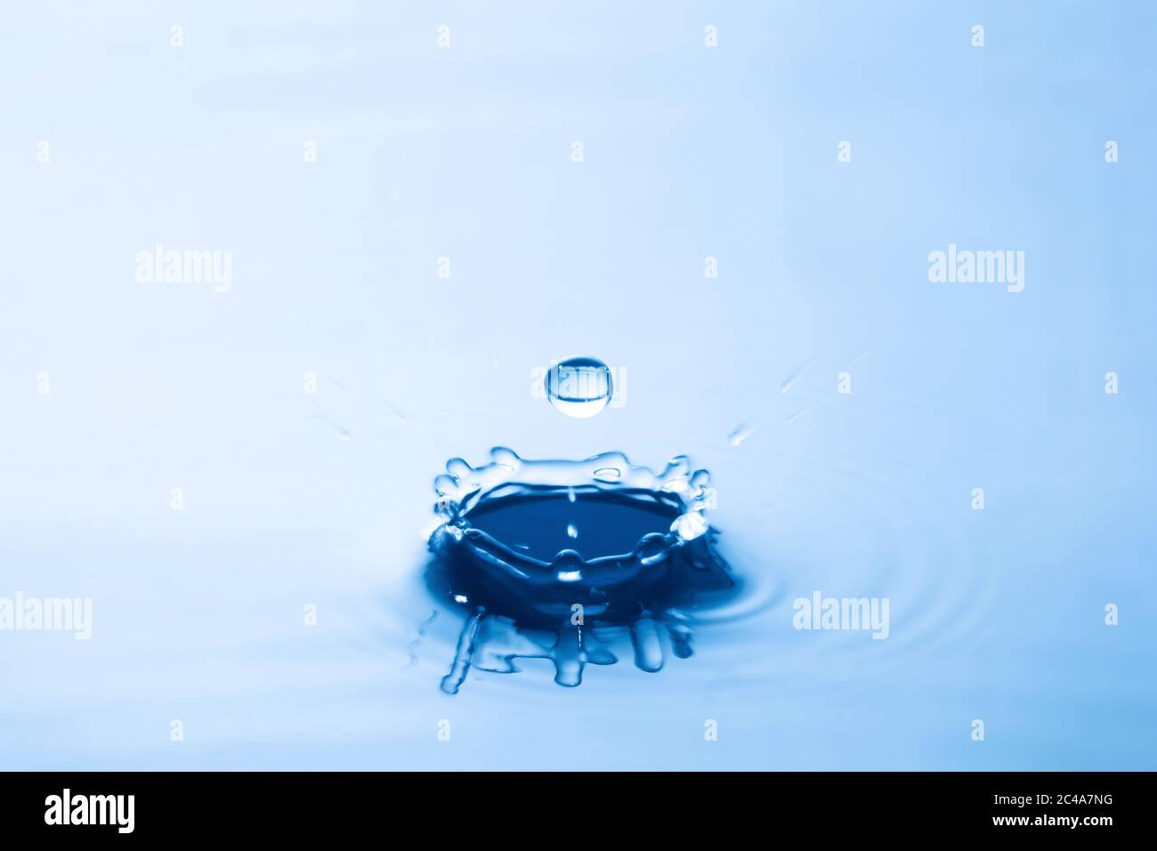 Water droplet falling impact with water surface. causing rings on water ...