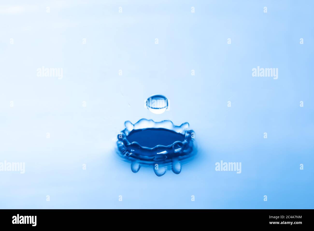 Water droplet falling impact with water surface. causing rings on water ...