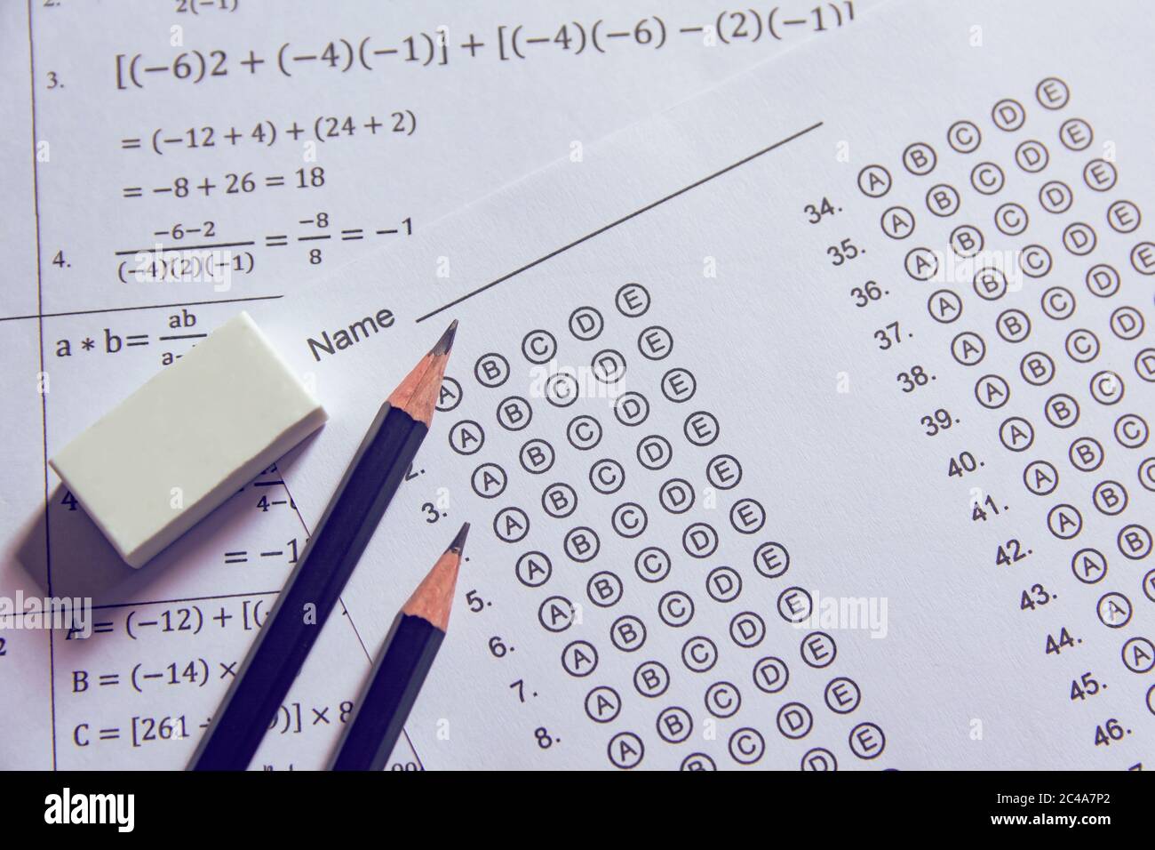 Pencil and eraser on answer sheets or Standardized test form with ...
