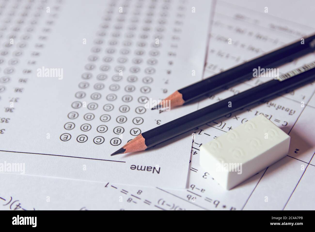 Pencil and eraser on answer sheets or Standardized test form with ...