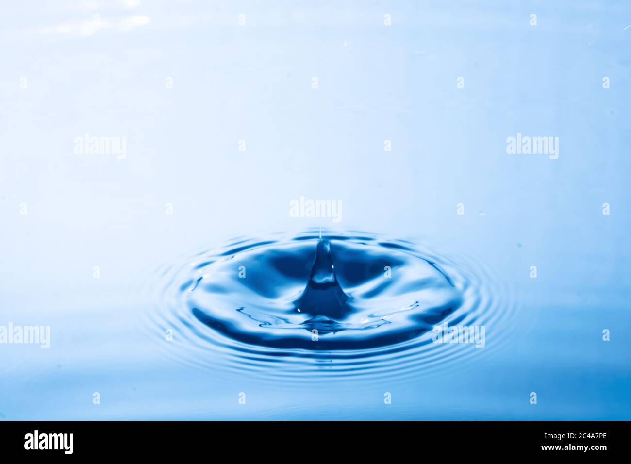 Water droplet falling impact with water surface. causing rings on water ...