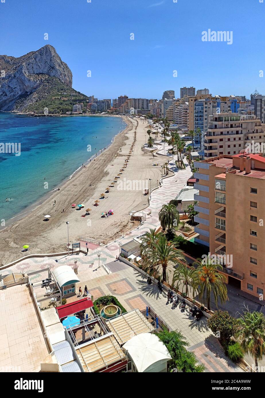 Sandy beach with parasols and vacationers, Penyal d'Ifac Natural Park ...
